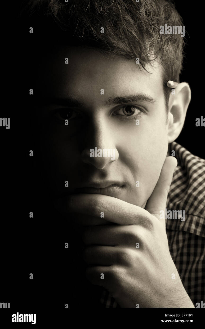 Portrait of young man thinking 4 Stock Photo - Alamy