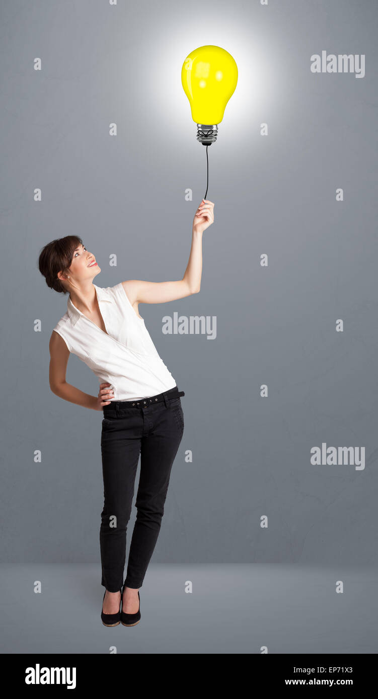 Pretty lady holding a light bulb balloon Stock Photo - Alamy