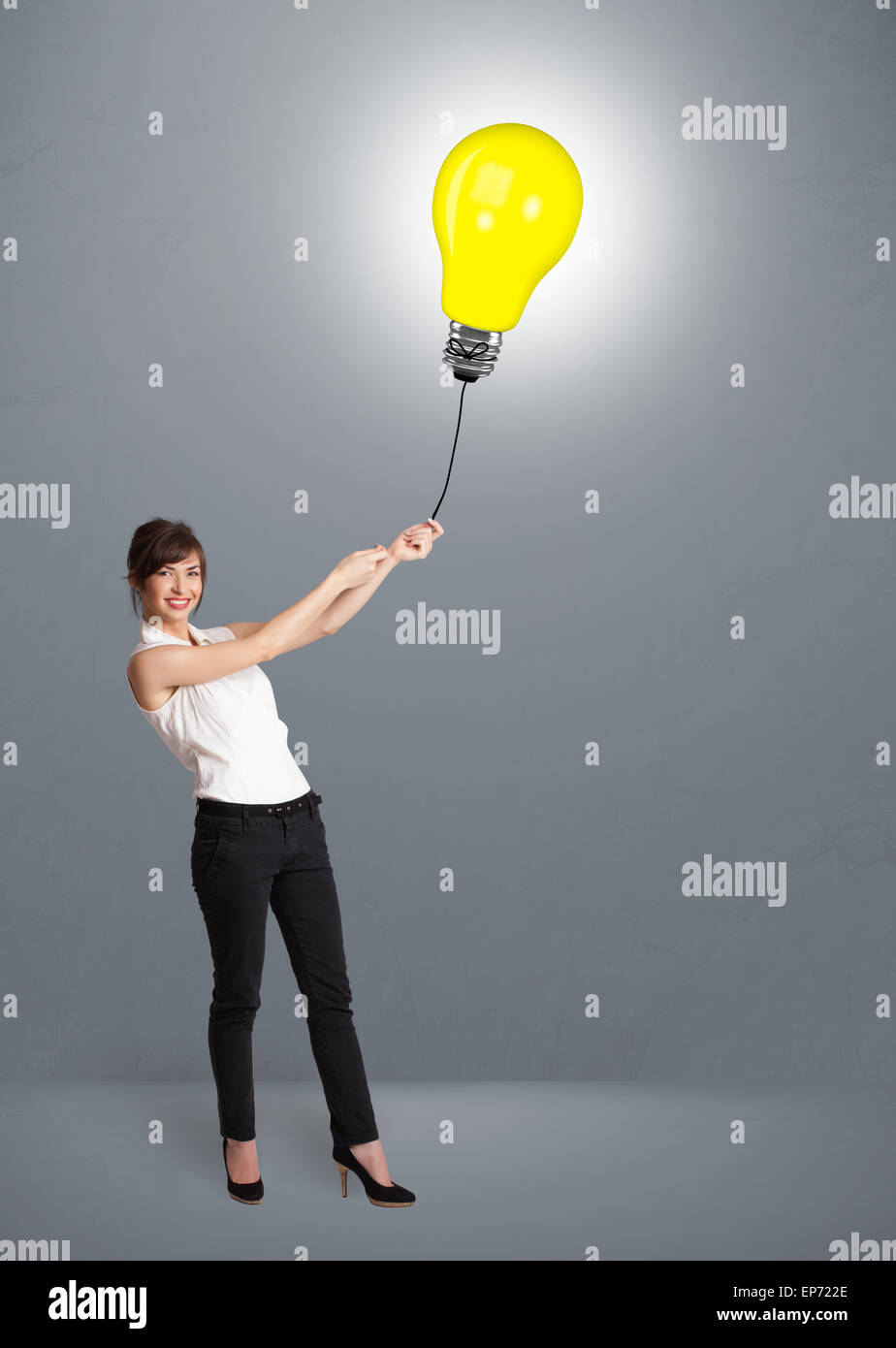 Pretty lady holding a light bulb balloon Stock Photo - Alamy