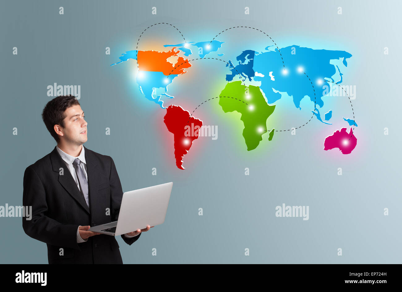 young man holding a laptop and presenting colorful world map Stock ...