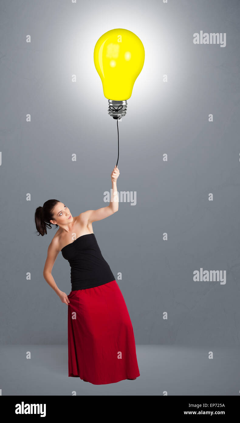 Pretty lady holding a light bulb balloon Stock Photo - Alamy