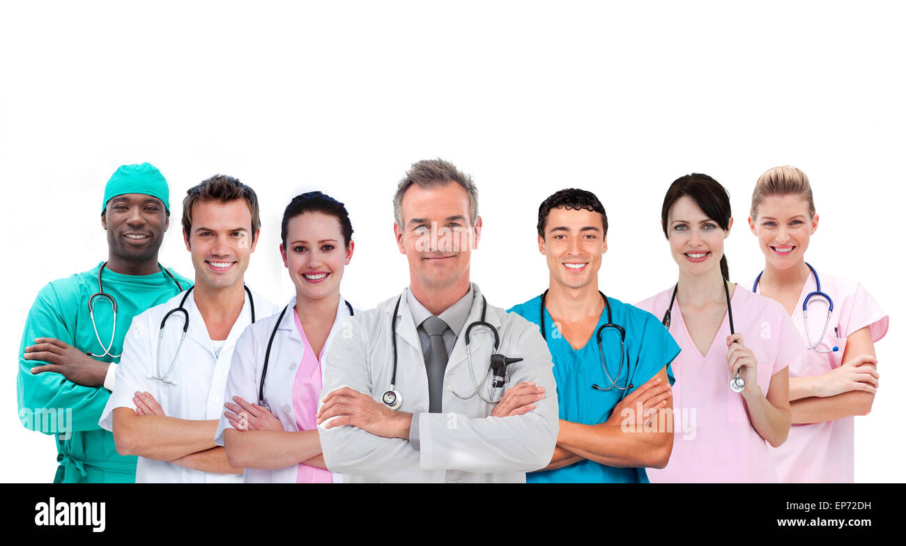 Smiling medical team standing arms crossed in line Stock Photo - Alamy
