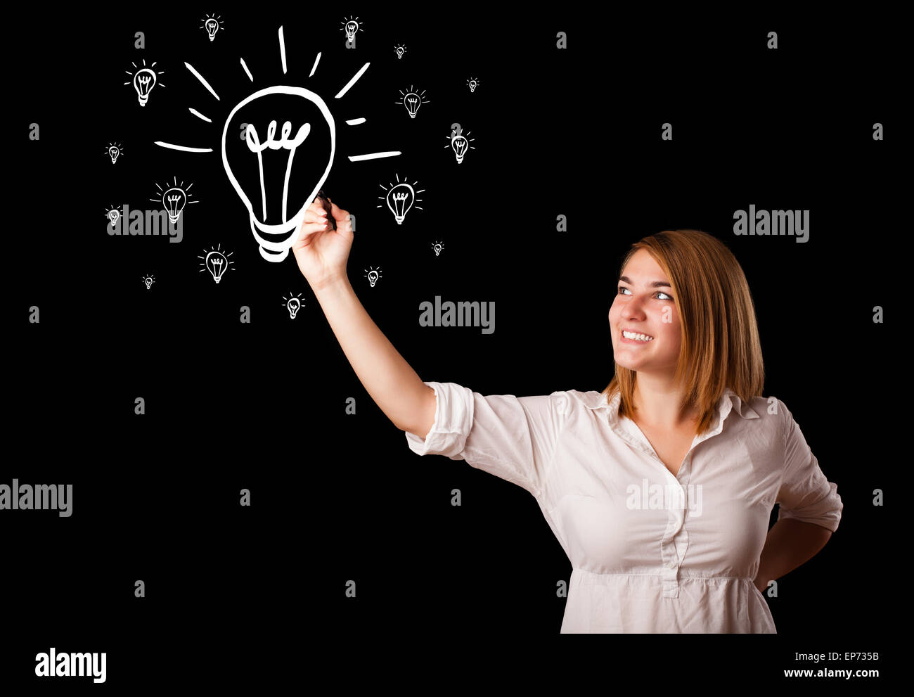 Woman drawing light bulb on whiteboard Stock Photo - Alamy