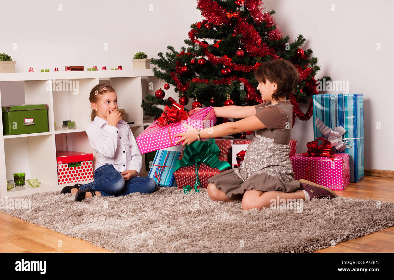 Happy kids with christmas present Stock Photo - Alamy