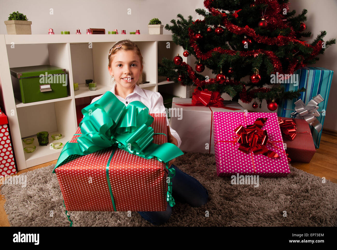 Happy kids with christmas present Stock Photo - Alamy