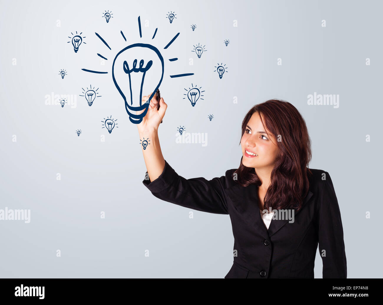 Woman drawing light bulb on whiteboard Stock Photo - Alamy