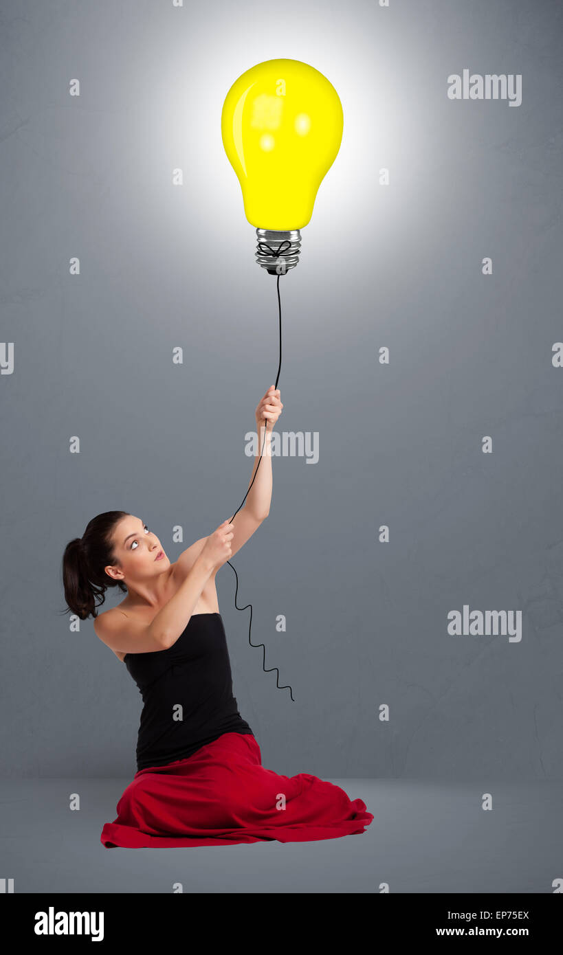 Pretty lady holding a light bulb balloon Stock Photo - Alamy