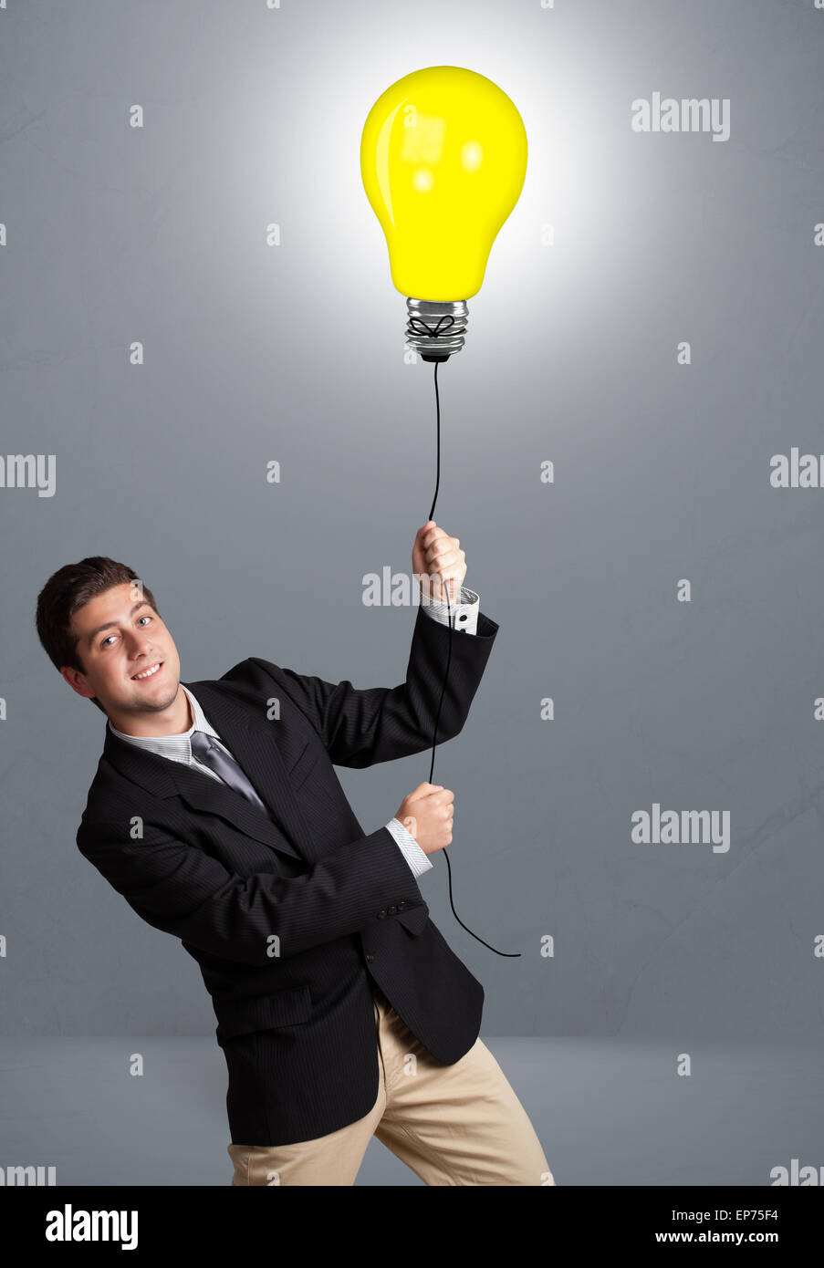 Handsome man holding light bulb balloon Stock Photo - Alamy