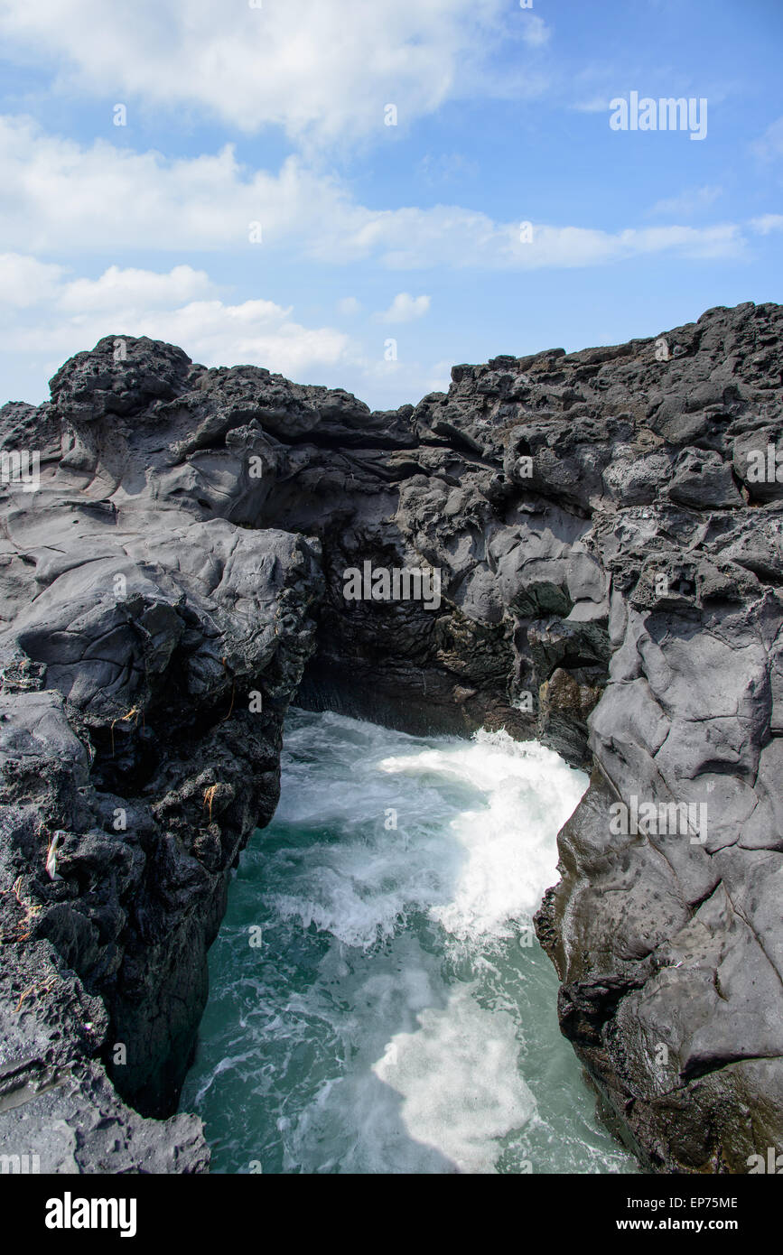 landscape with Spray of water by struck Seawater through tunnel between ...