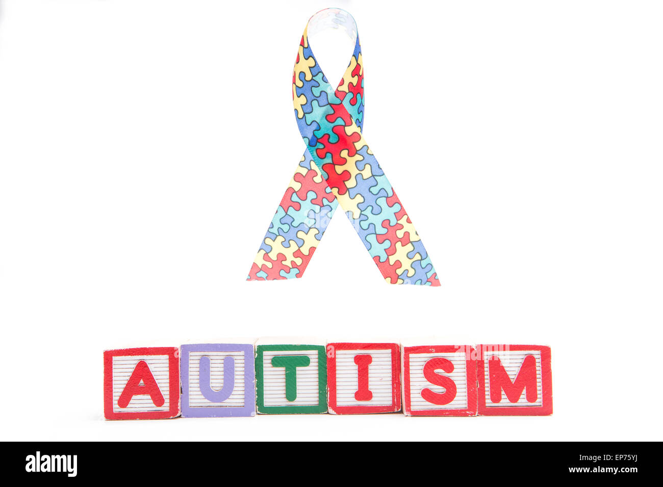 Autism awareness ribbon above letter blocks spelling autism Stock Photo ...