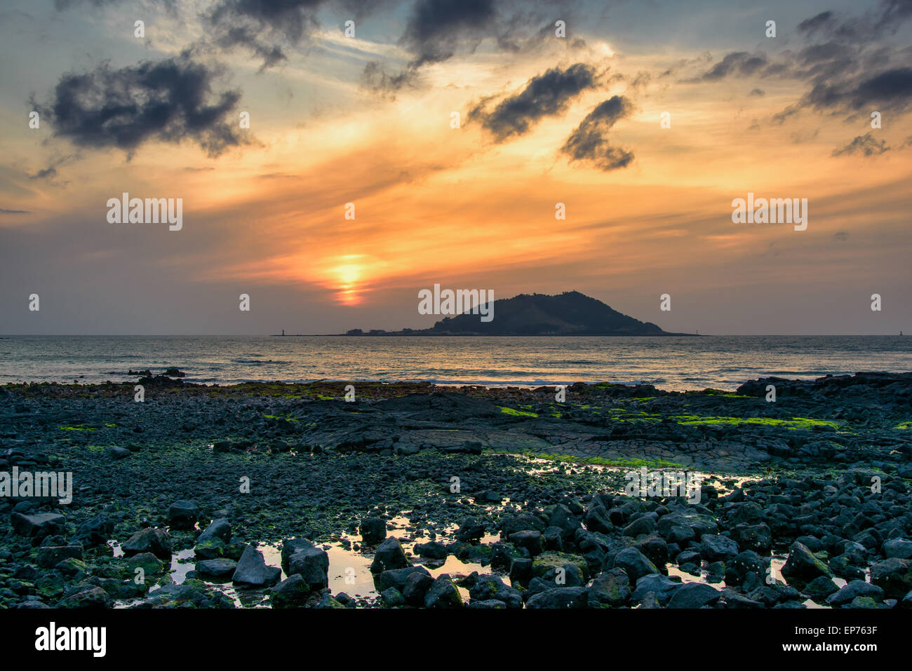 Sunset with Biyangdo island in a cloudy day, view from Hyeopjae beach ...
