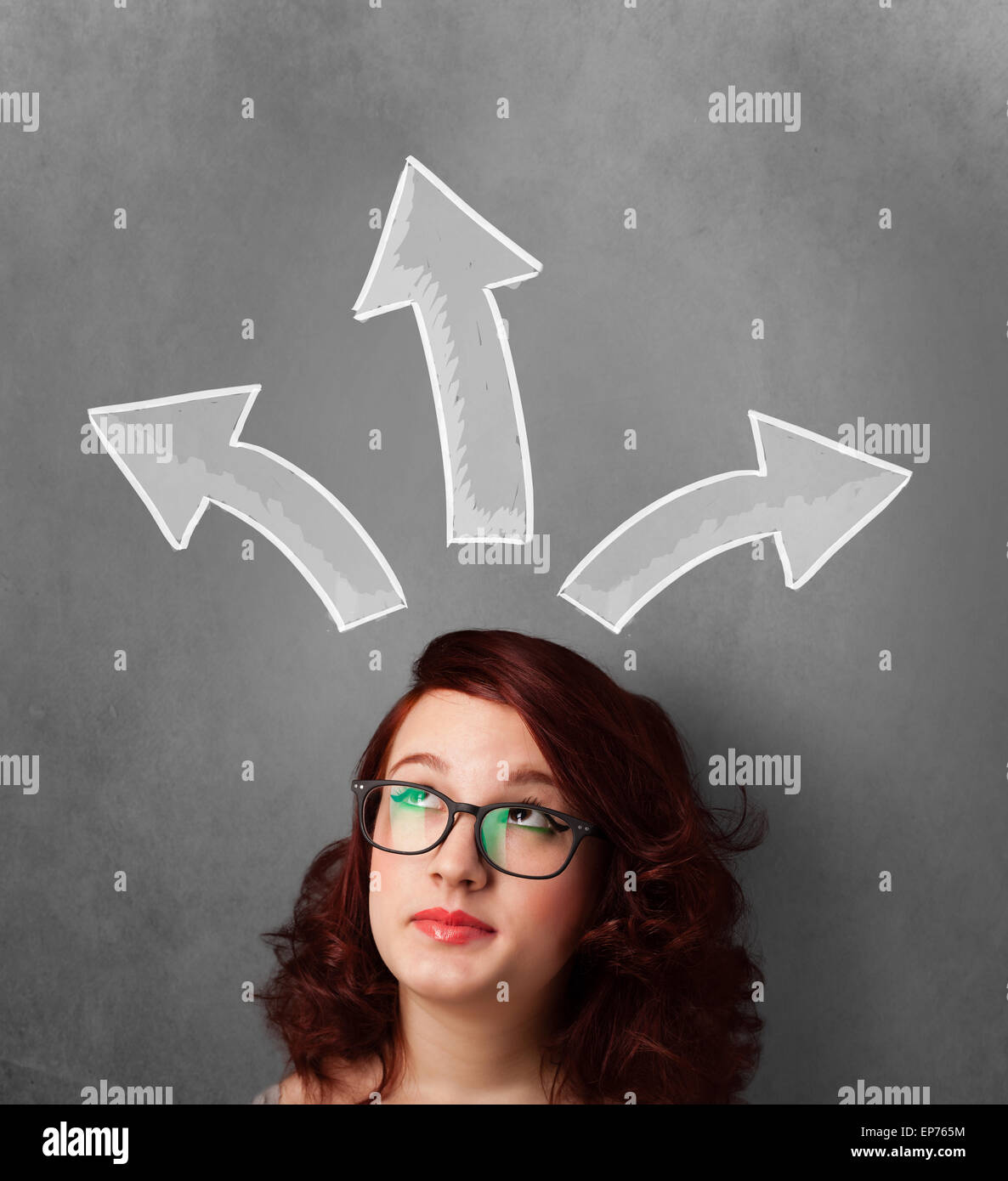 Young woman thinking with arrows above her head Stock Photo - Alamy