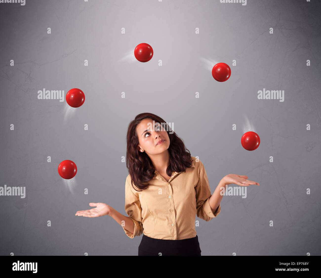 young girl standing and juggling with red balls Stock Photo - Alamy
