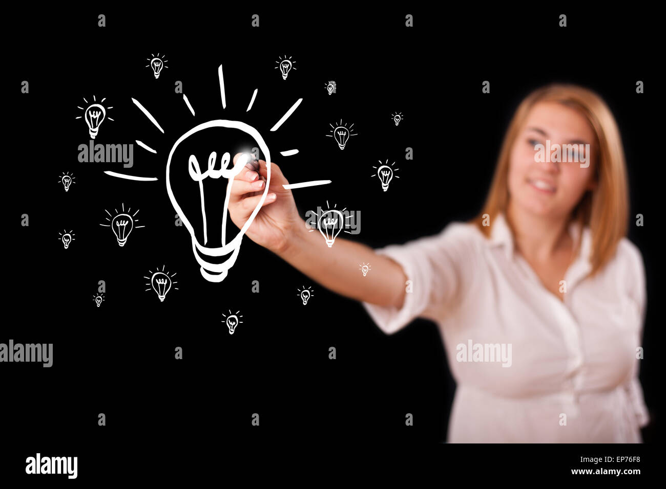 Woman drawing light bulb on whiteboard Stock Photo - Alamy
