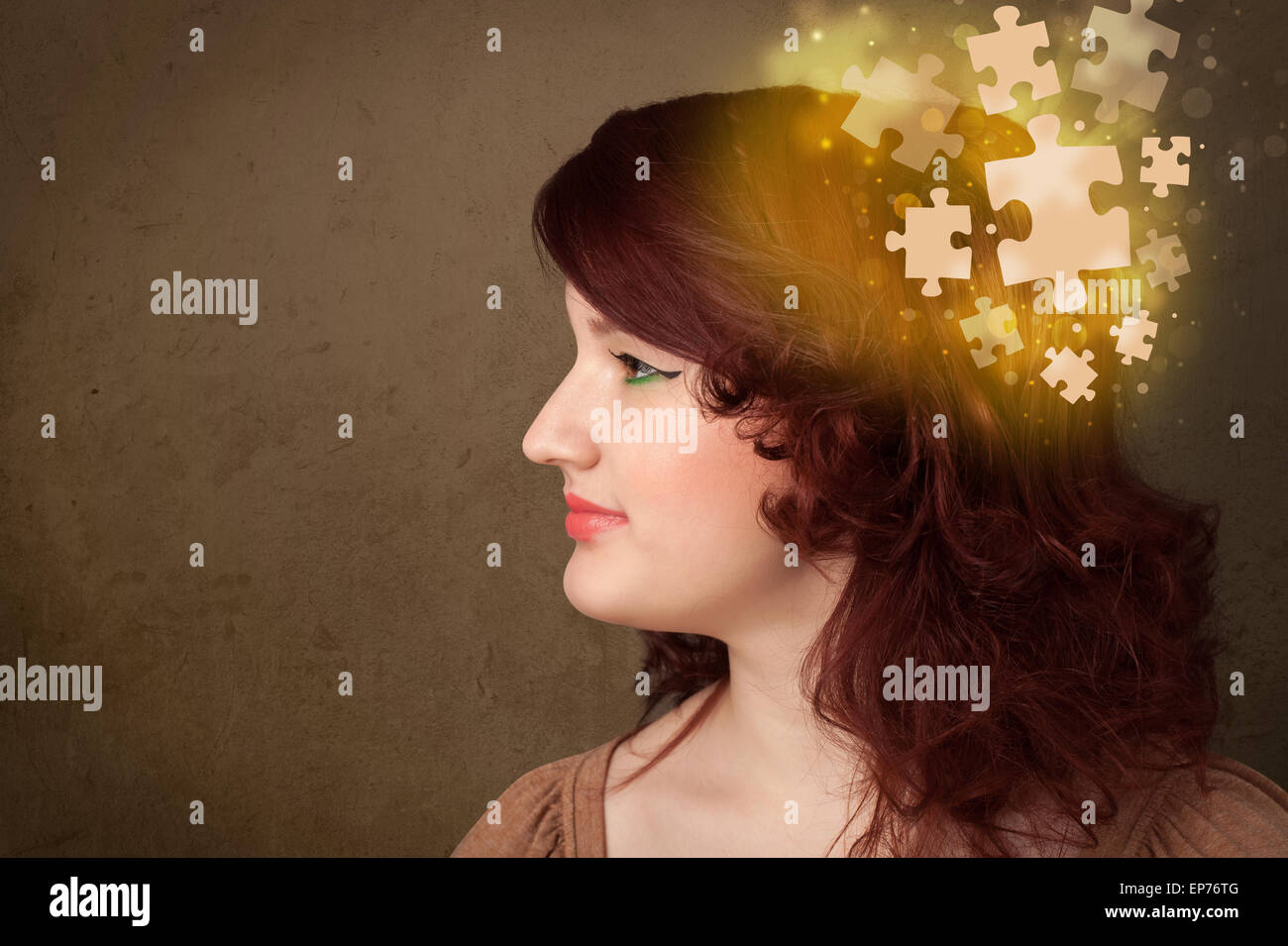 Young person thinking with glowing puzzle mind Stock Photo - Alamy