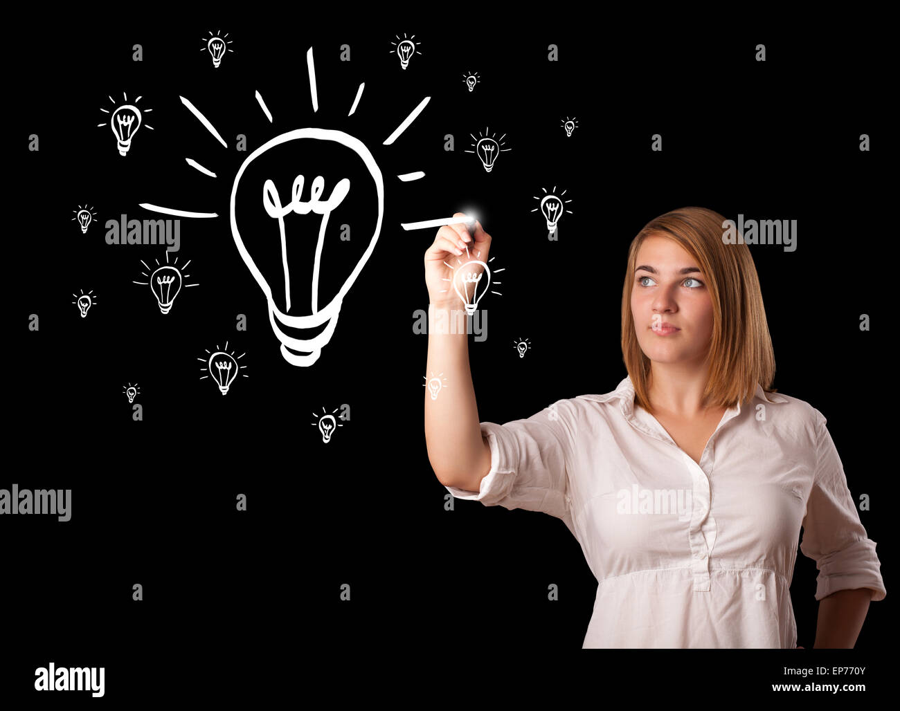 Woman drawing light bulb on whiteboard Stock Photo - Alamy