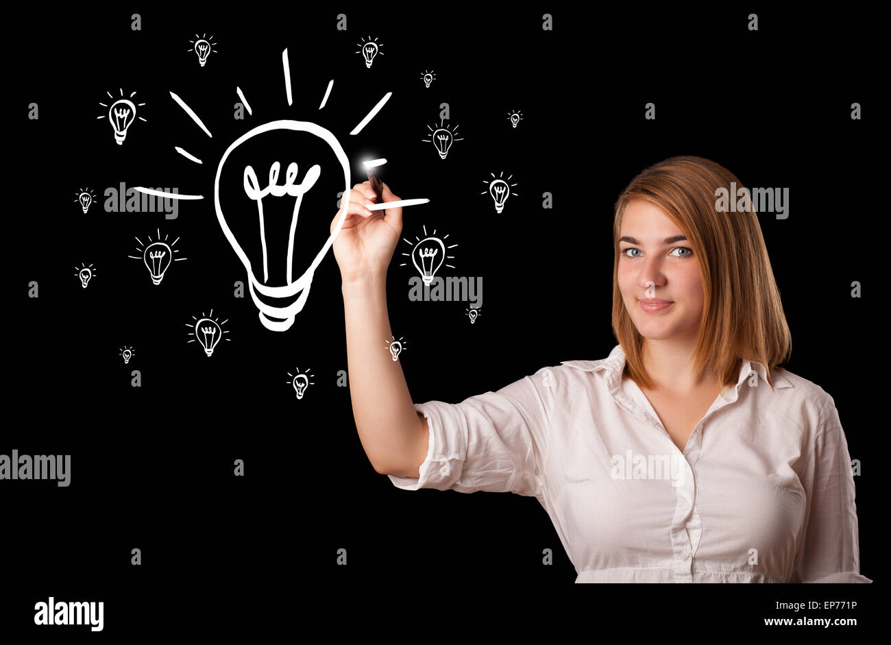 Woman drawing light bulb on whiteboard Stock Photo - Alamy