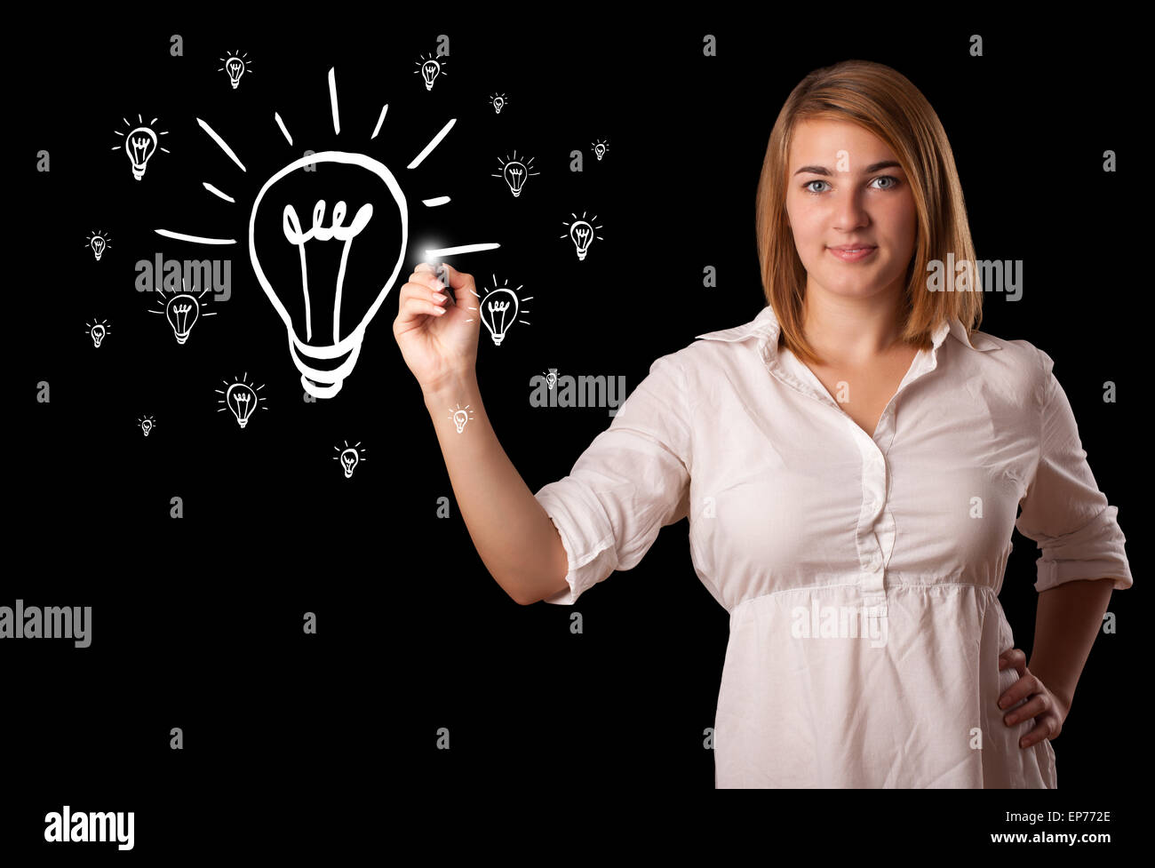 Woman drawing light bulb on whiteboard Stock Photo - Alamy