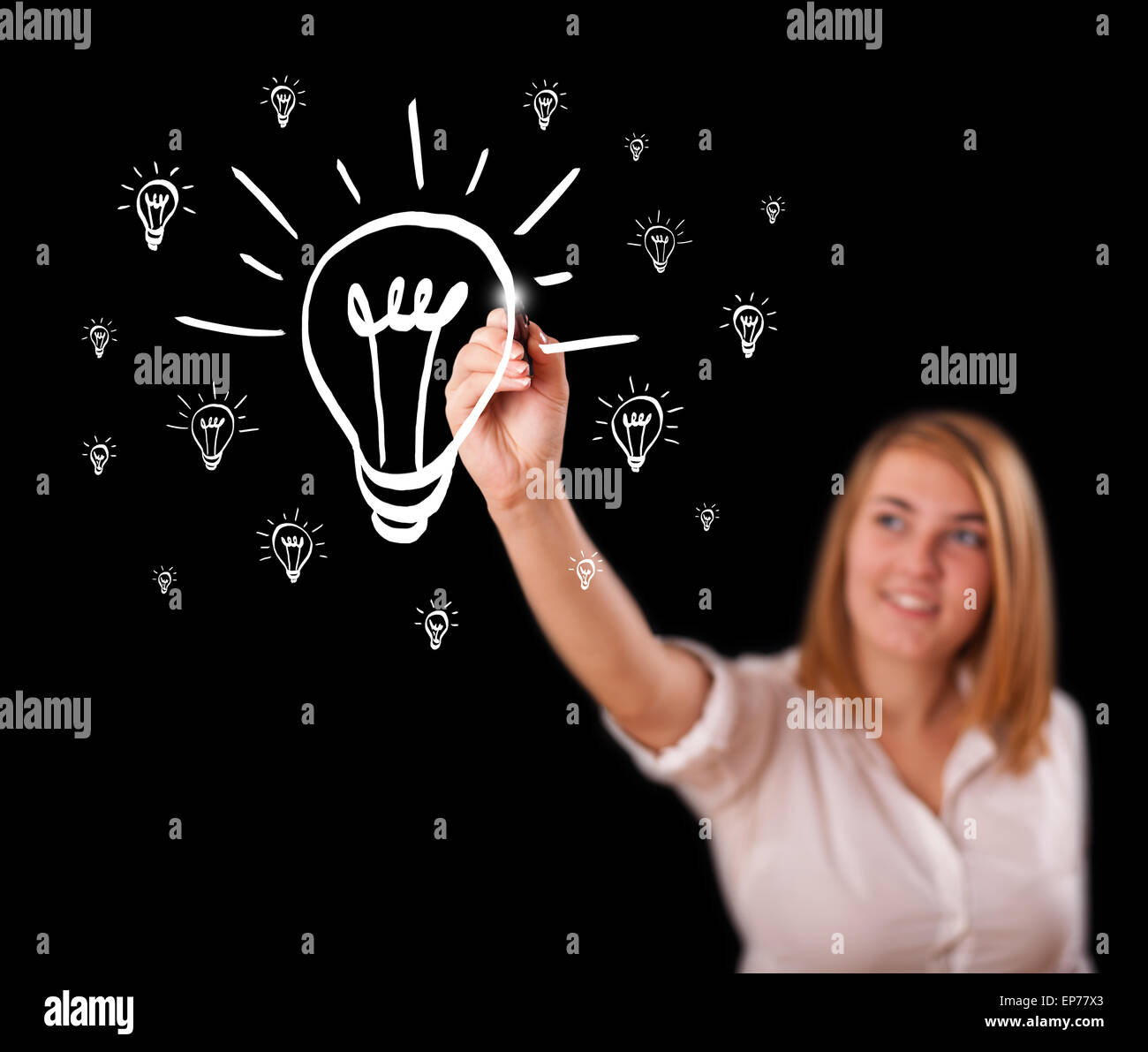 Woman drawing light bulb on whiteboard Stock Photo - Alamy