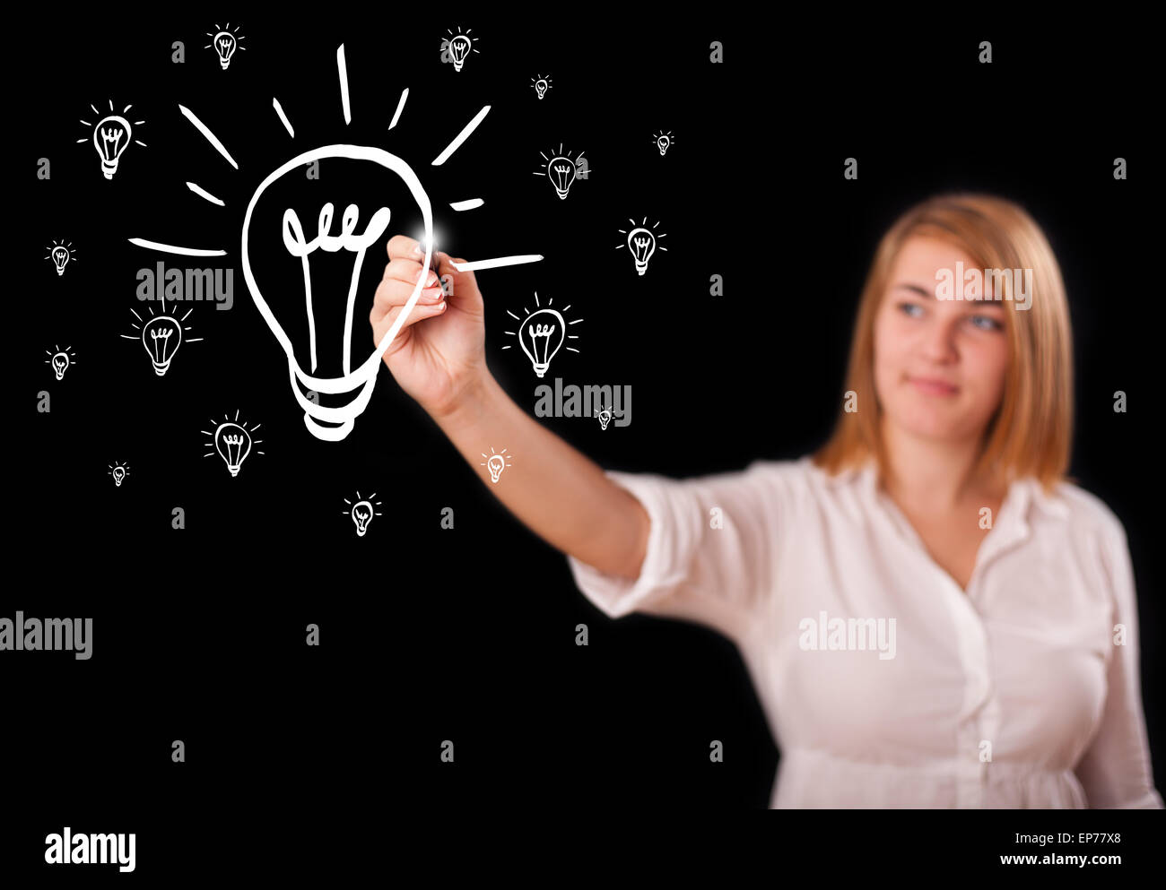 Woman drawing light bulb on whiteboard Stock Photo - Alamy