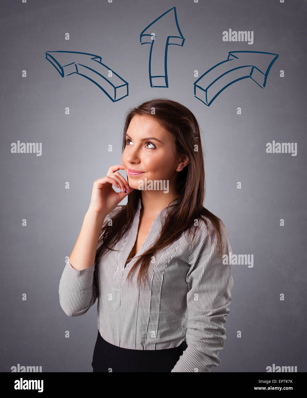 Pretty lady thinking with arrows overhead Stock Photo - Alamy