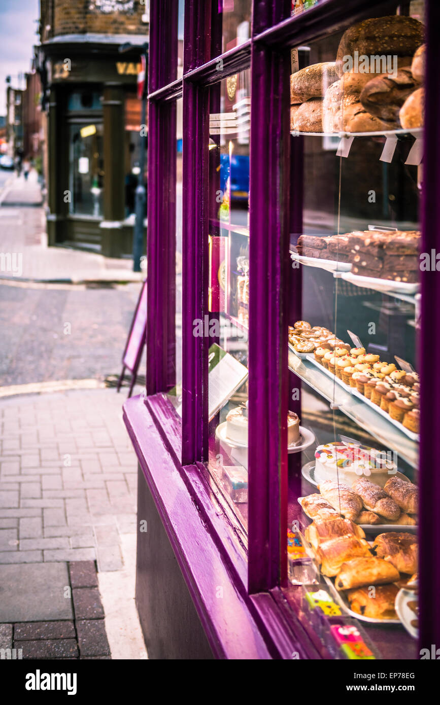 Freshly baked pastries and cakes on display in a patisserie window ...