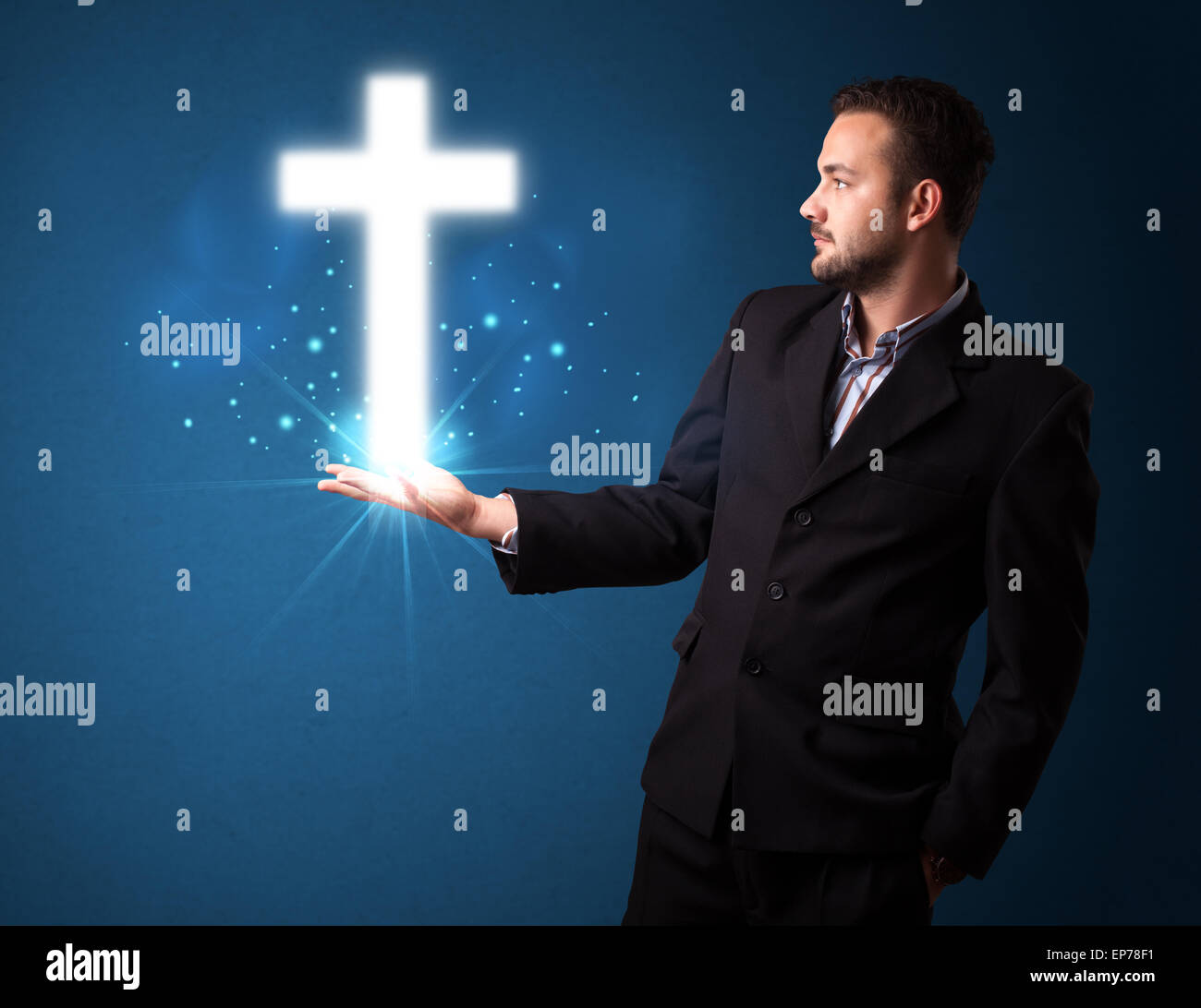 Glowing cross in the hand of a businessman Stock Photo - Alamy