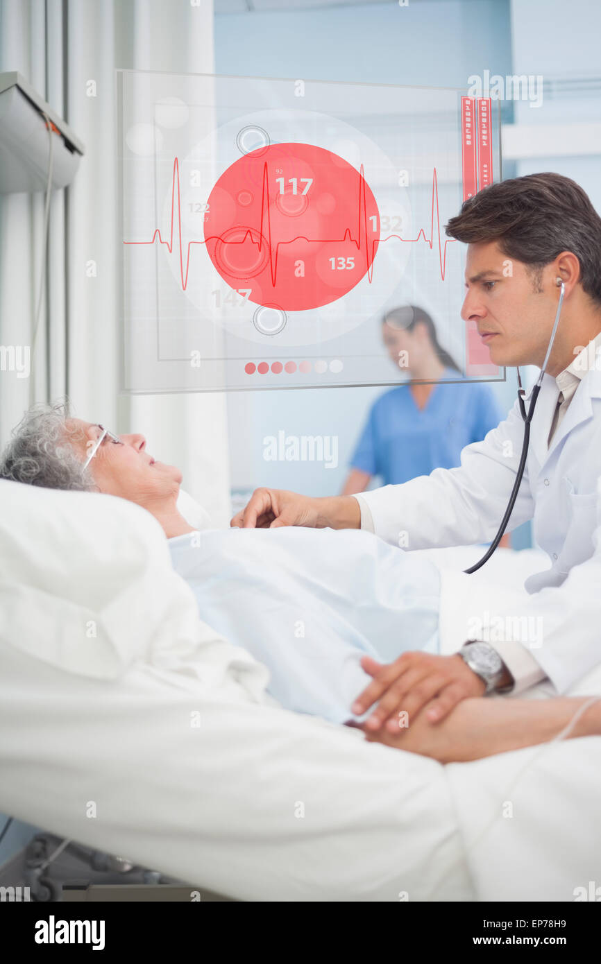 Doctor checking pulse of elderly patient beside screen displaying ECG ...