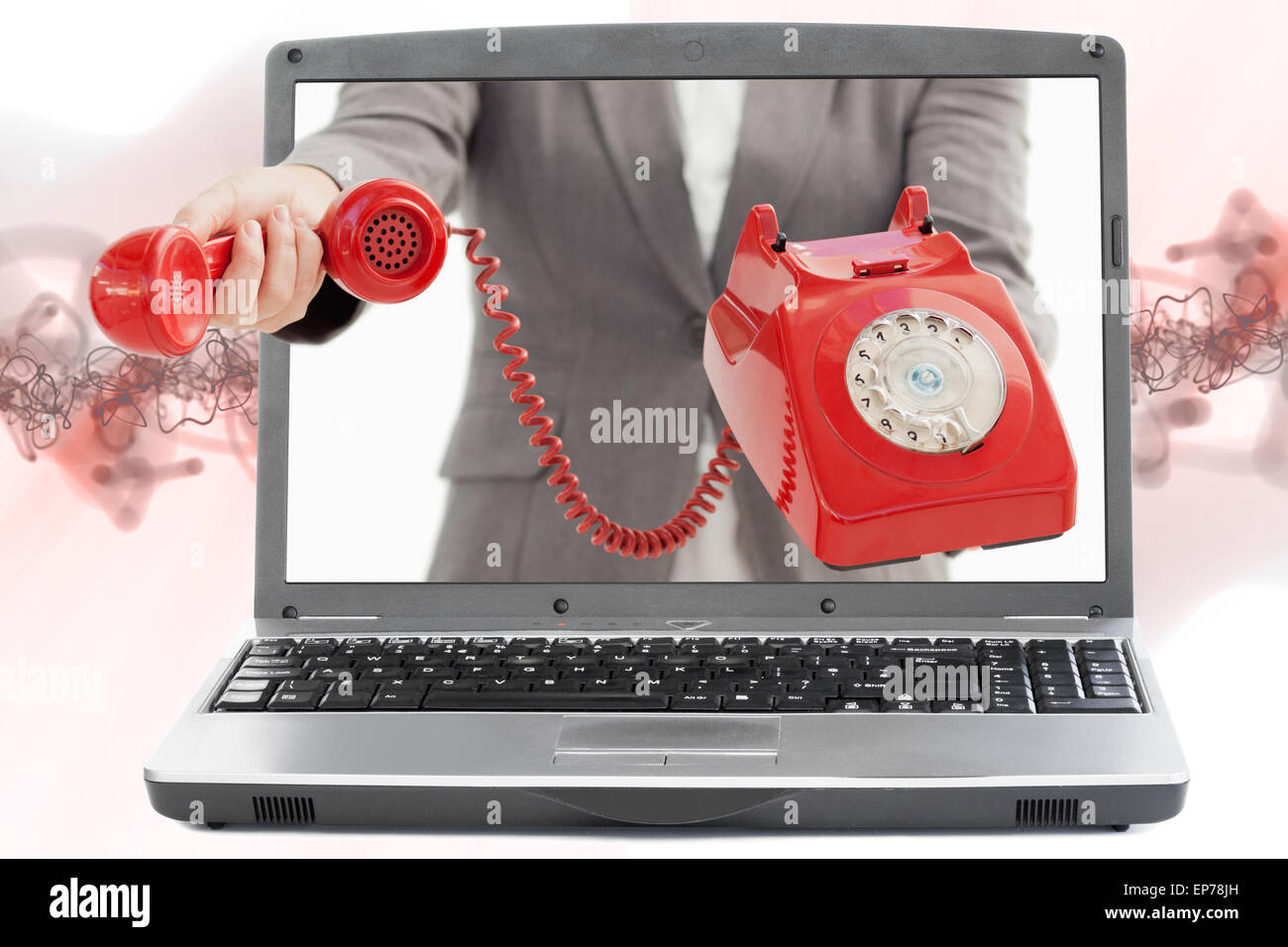 Woman reaching out from laptop handing phone receiver Stock Photo - Alamy
