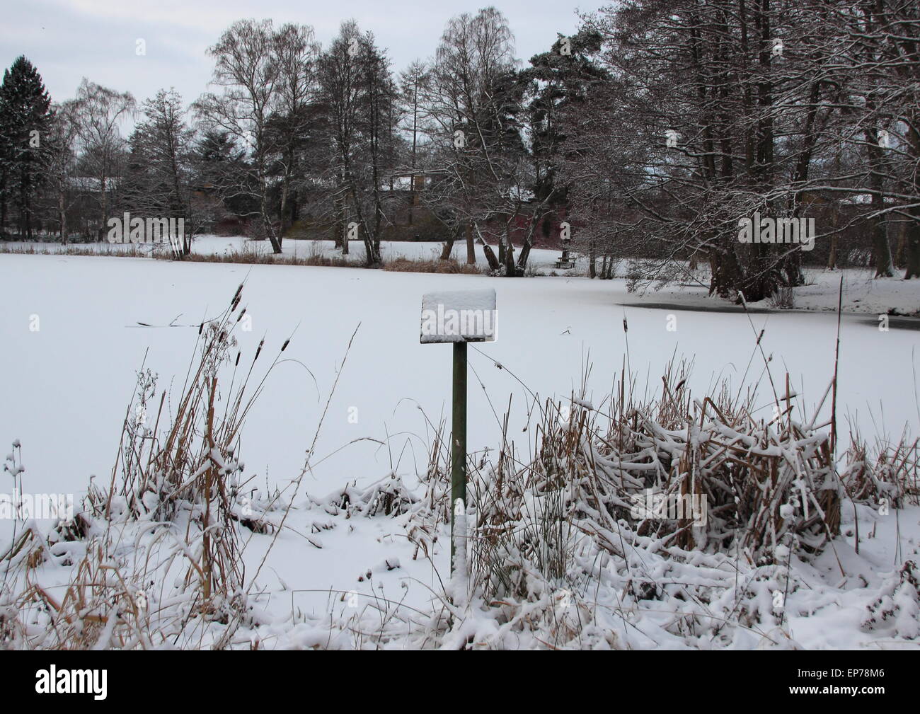 Snow covered sign at winter frozen lake Stock Photo - Alamy