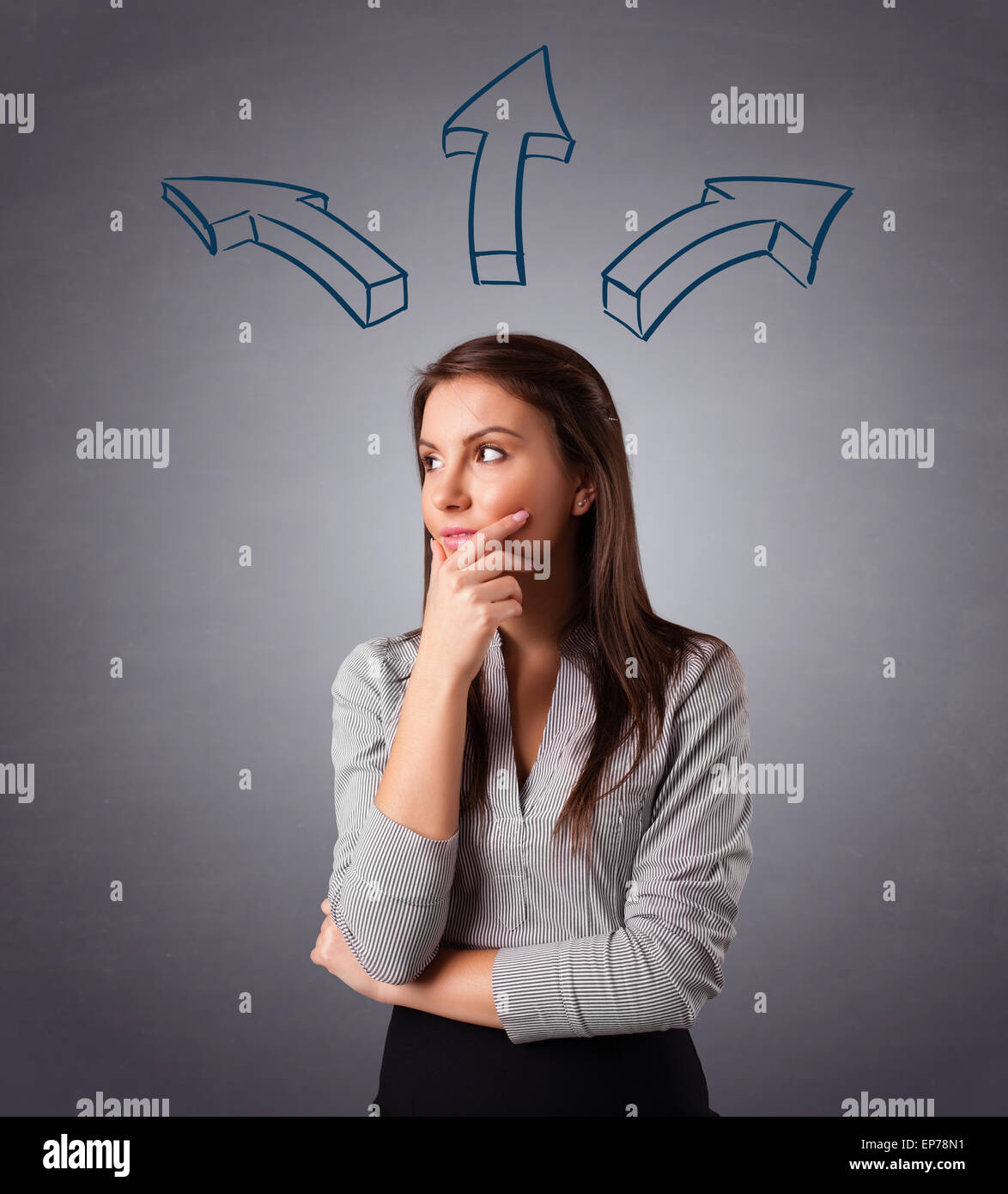 Pretty lady thinking with arrows overhead Stock Photo - Alamy