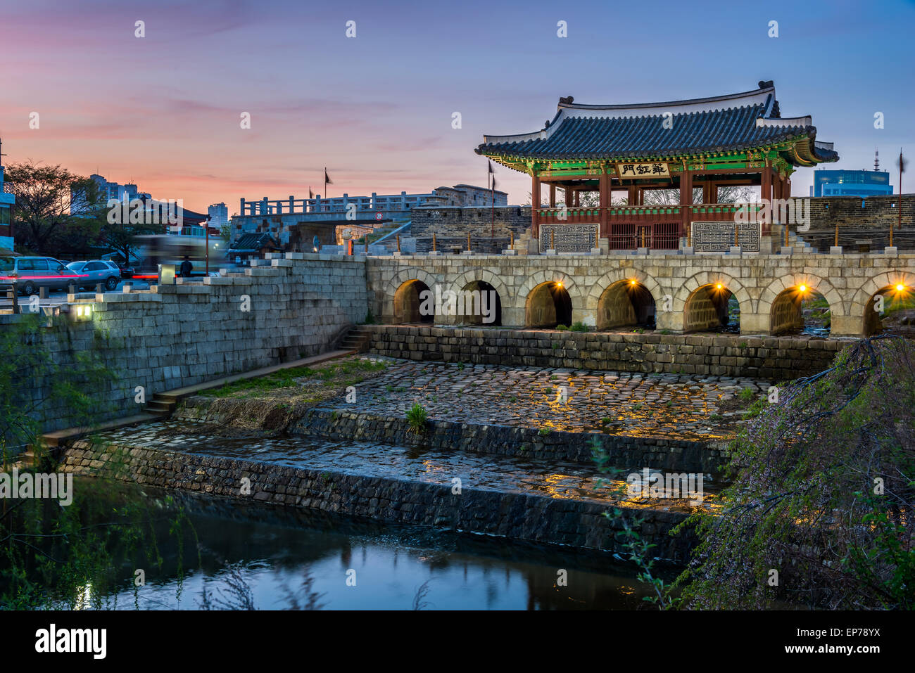 The sun sets behind Hwahongmun Gate at Hwaseong Fortress in Suwon ...