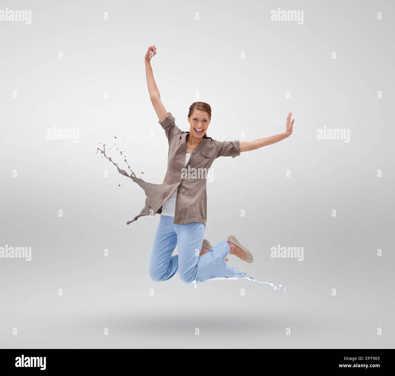 Woman jumping with clothes turning to paint splatters Stock Photo - Alamy