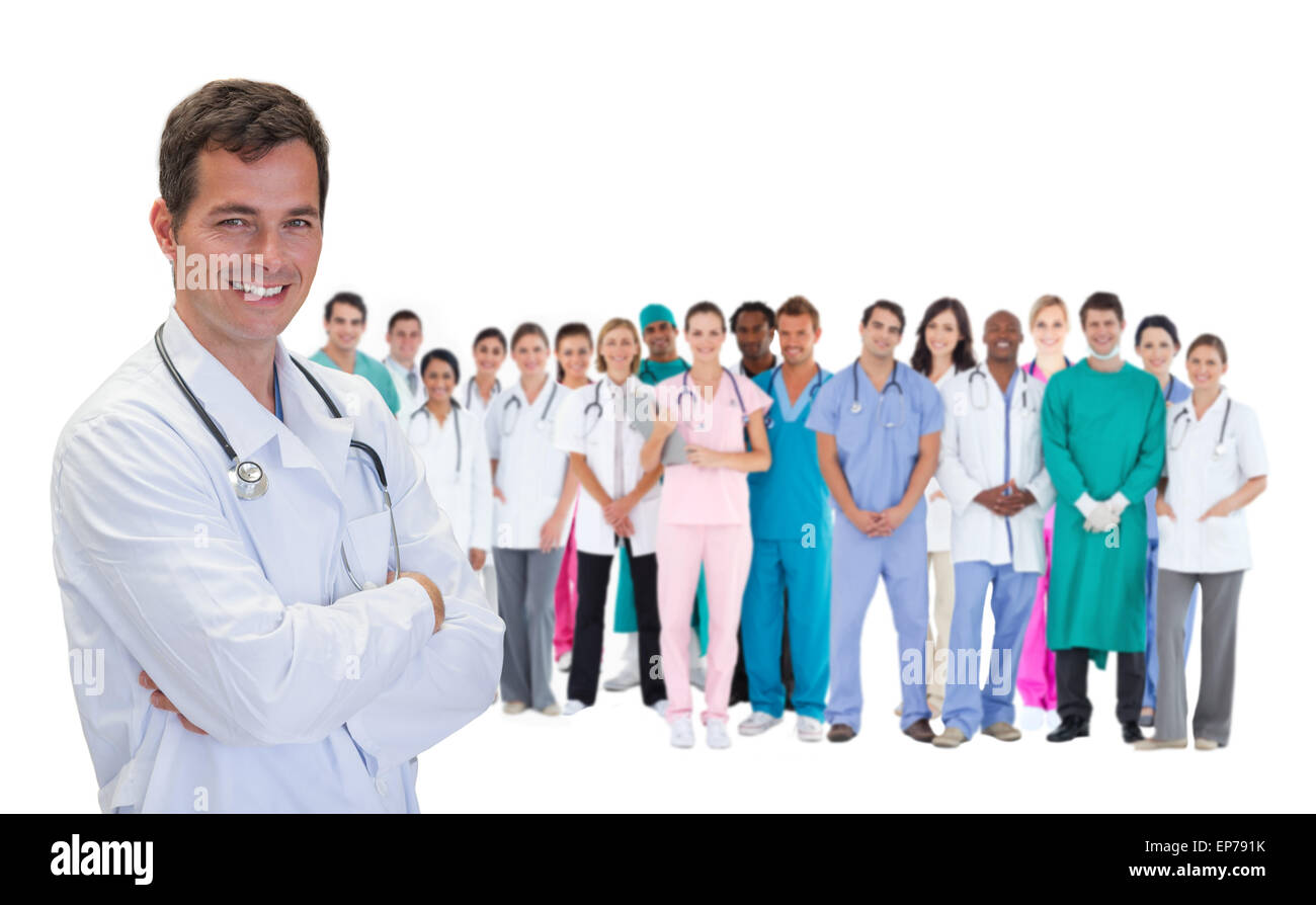 Smiling doctor in front of a team of doctors standing together Stock ...