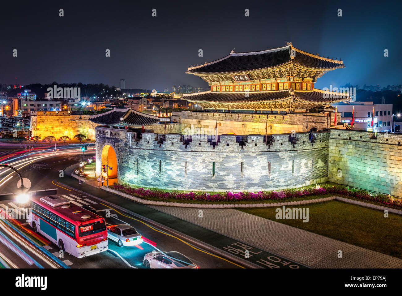 Night traffic blurs past Janganmun Gate at Hwaseong Fortress in Suwon ...