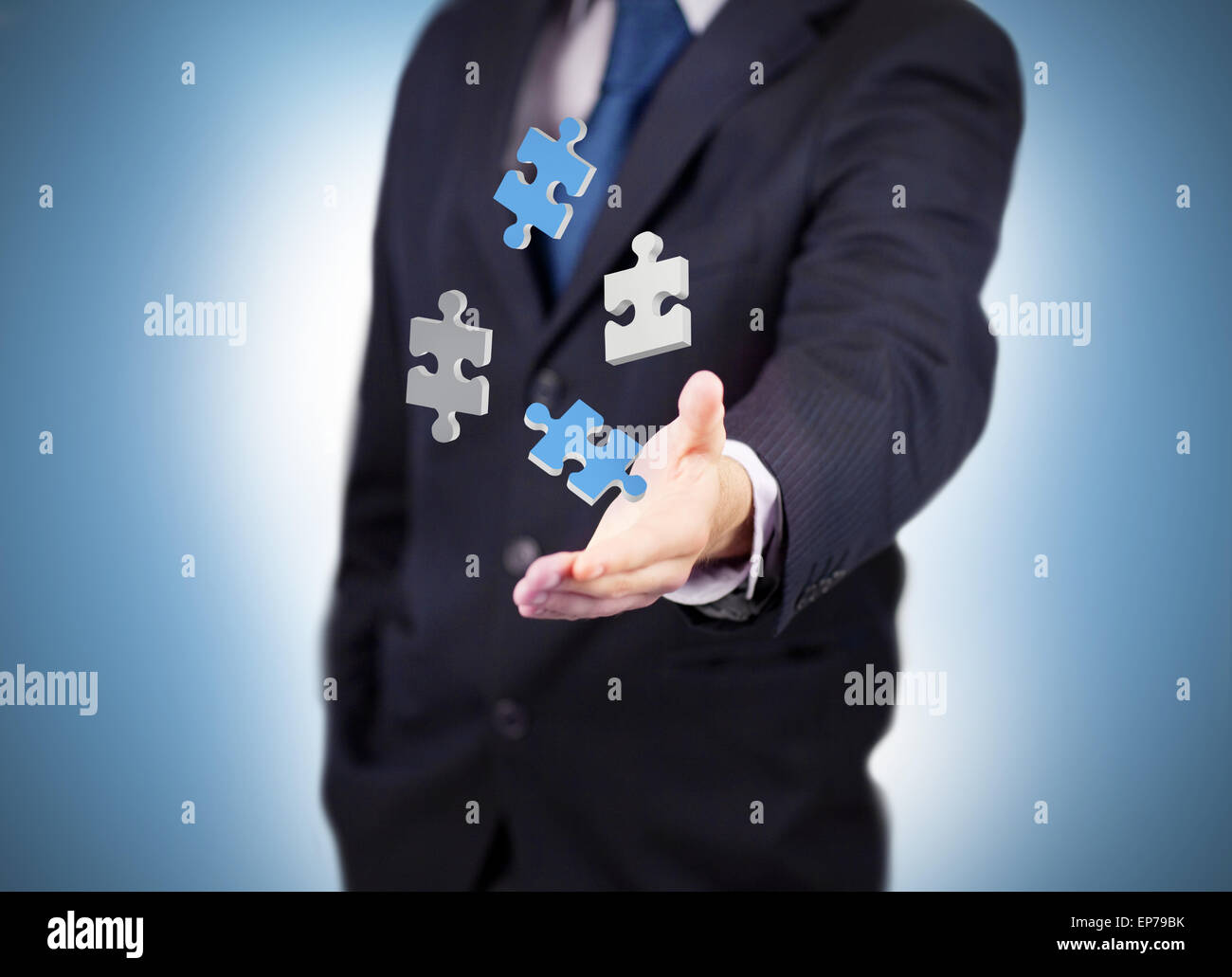 Businessman with digital white and blue puzzles Stock Photo - Alamy