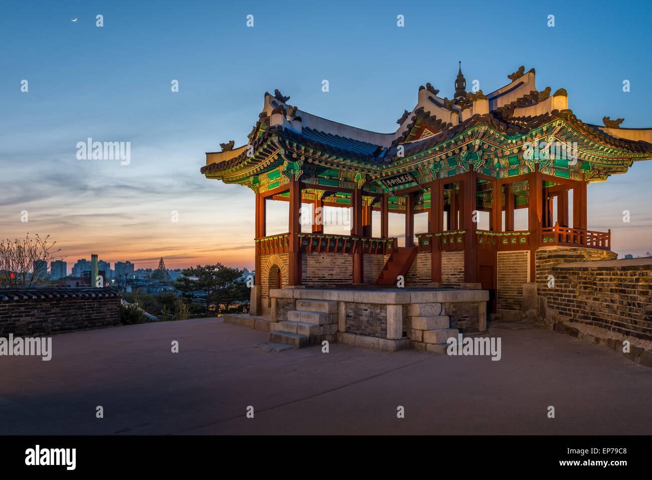A watchtower at Hwaseong Fortress lit up at sunset in Suwon, South ...