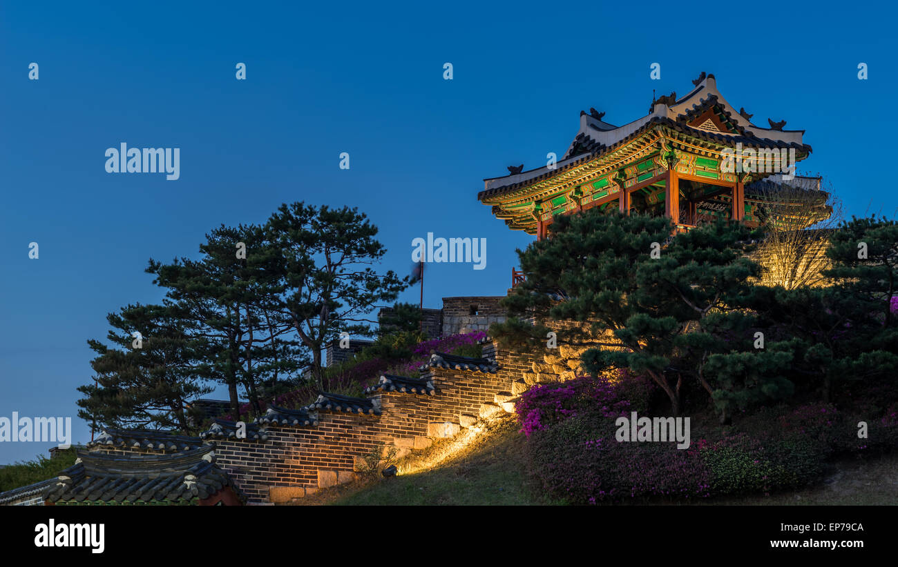 A watchtower at Hwaseong Fortress lit up at sunset in Suwon, South ...