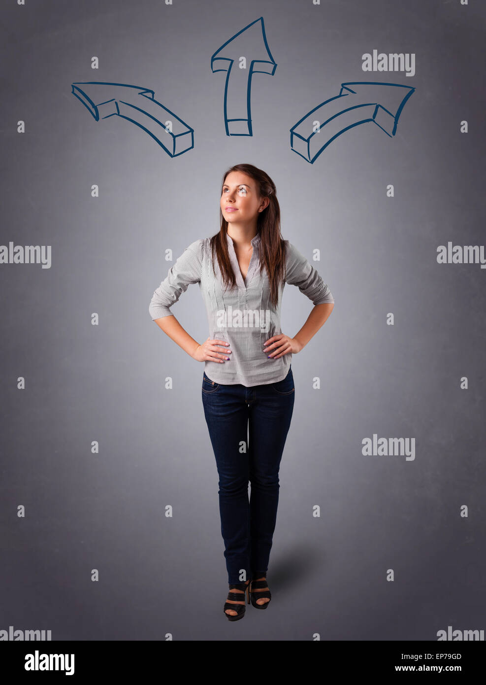 Pretty lady thinking with arrows overhead Stock Photo - Alamy