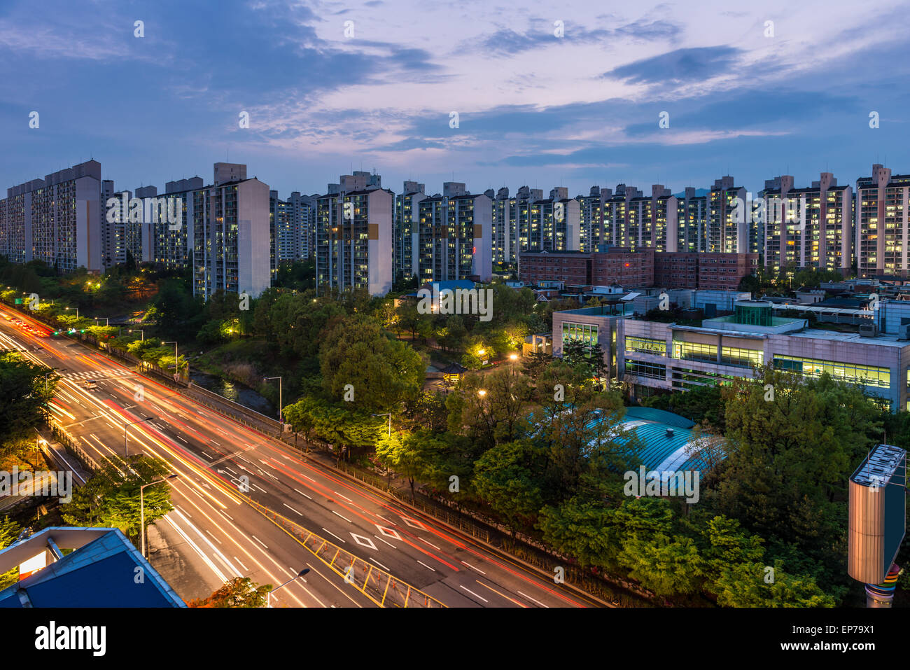 The sun sets over the endless apartment buildings among the suburbs of ...