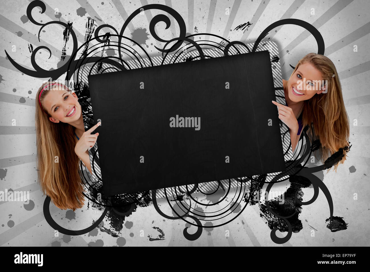 Girls pointing to black copy space with artistic swirl frame Stock ...