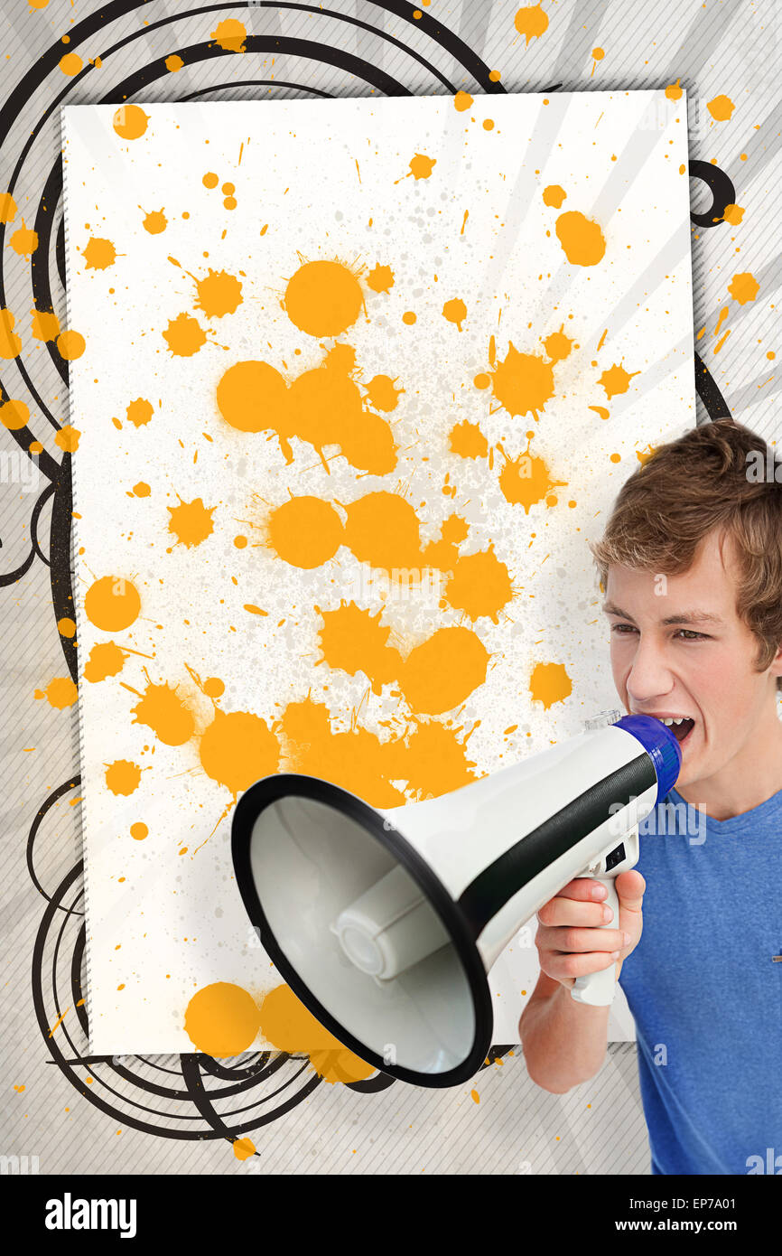 Young man shouting through megaphone in front of copy space with yellow ...