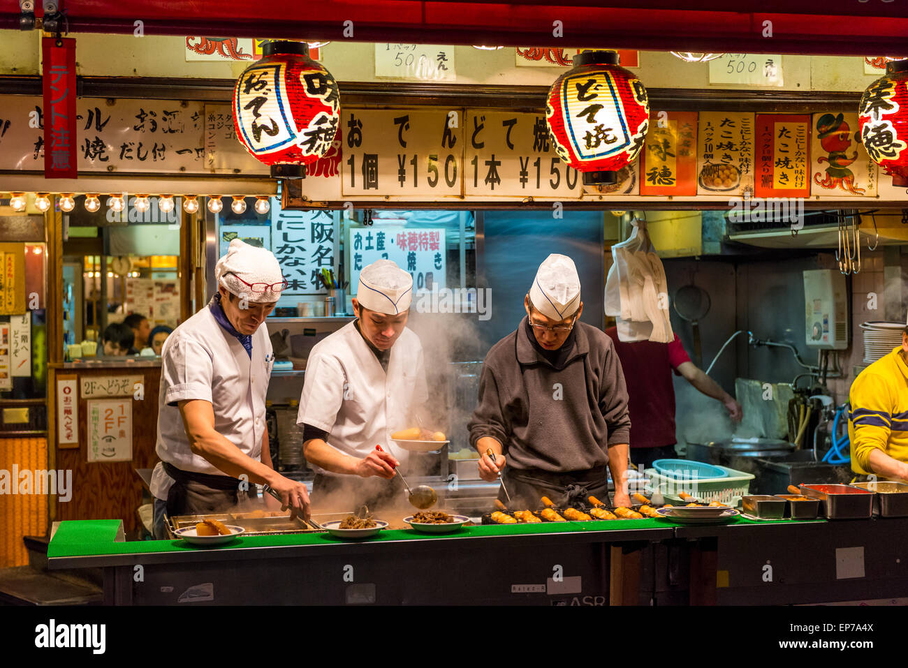 Japanese chefs prepare takoyaki and other snack foods at a stall in ...