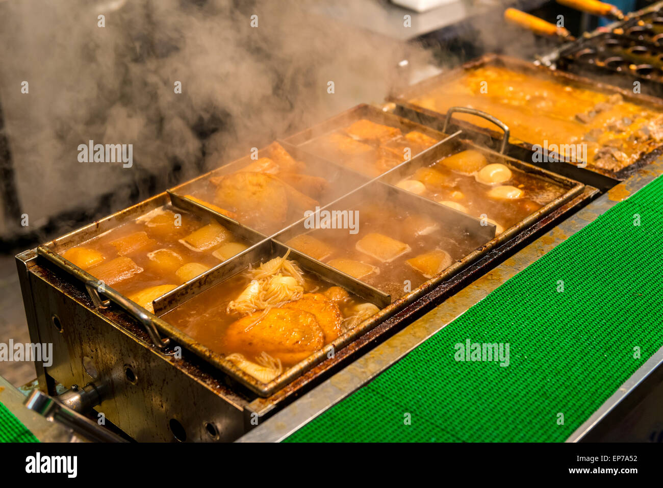 Oden and ramen cooking at a street food stall in Osaka, Japan Stock ...