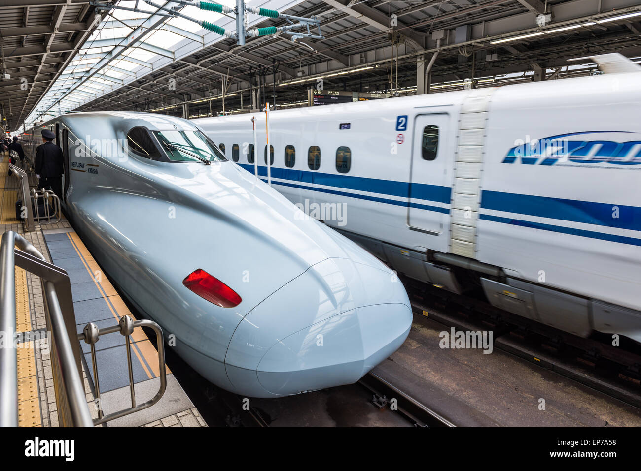 Passengers board the Shinkansen bullet train at Shin Osaka Station on ...