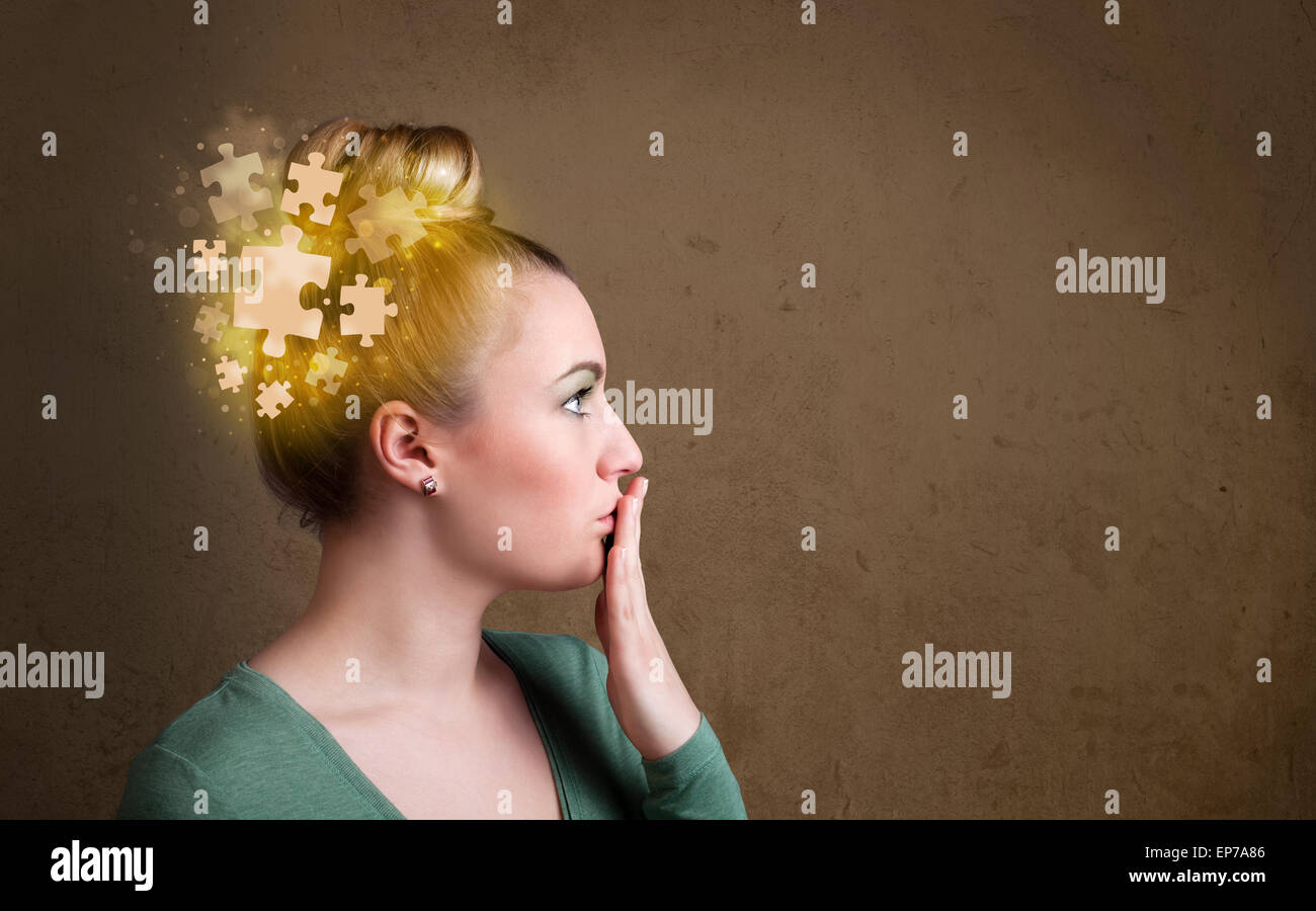 Young person thinking with glowing puzzle mind Stock Photo - Alamy