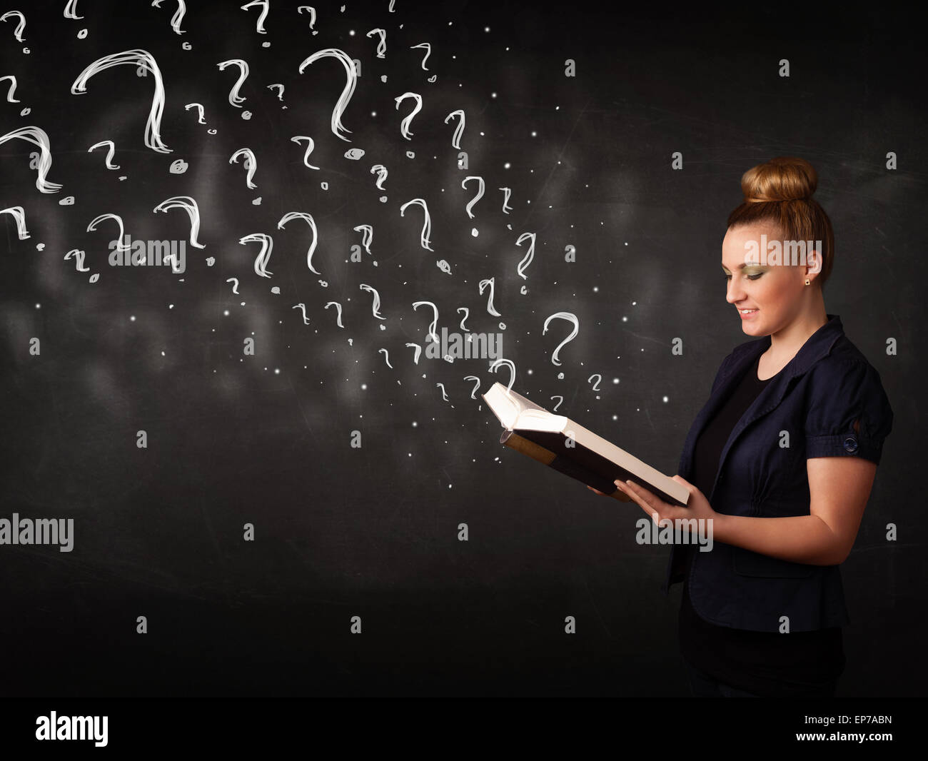 Pretty woman reading a book with question marks coming out from it ...