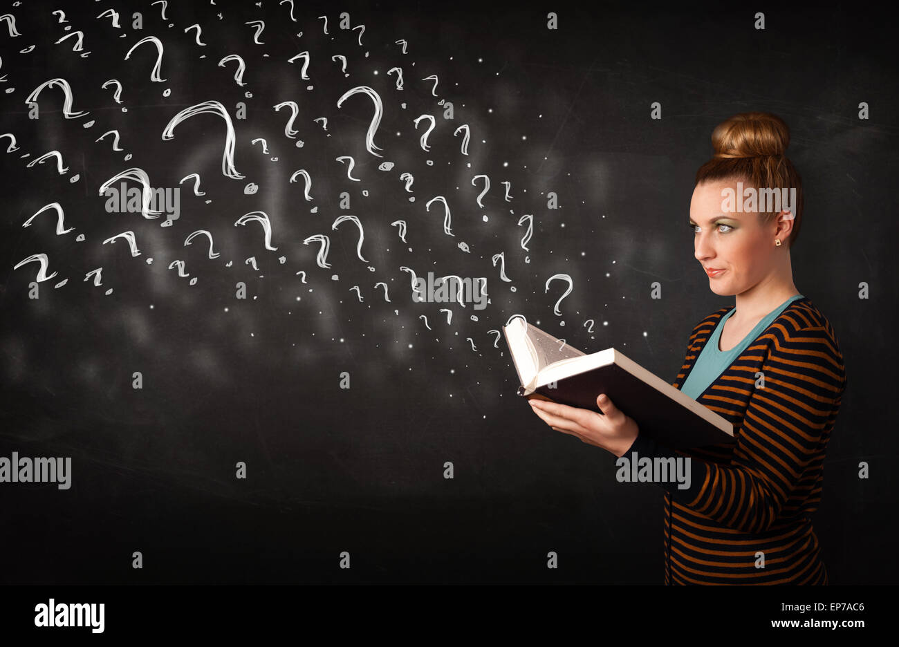Pretty woman reading a book with question marks coming out from it ...