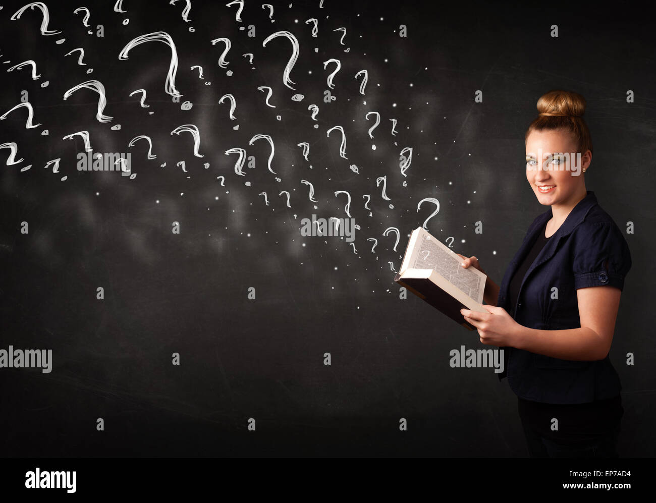 Pretty woman reading a book with question marks coming out from it ...