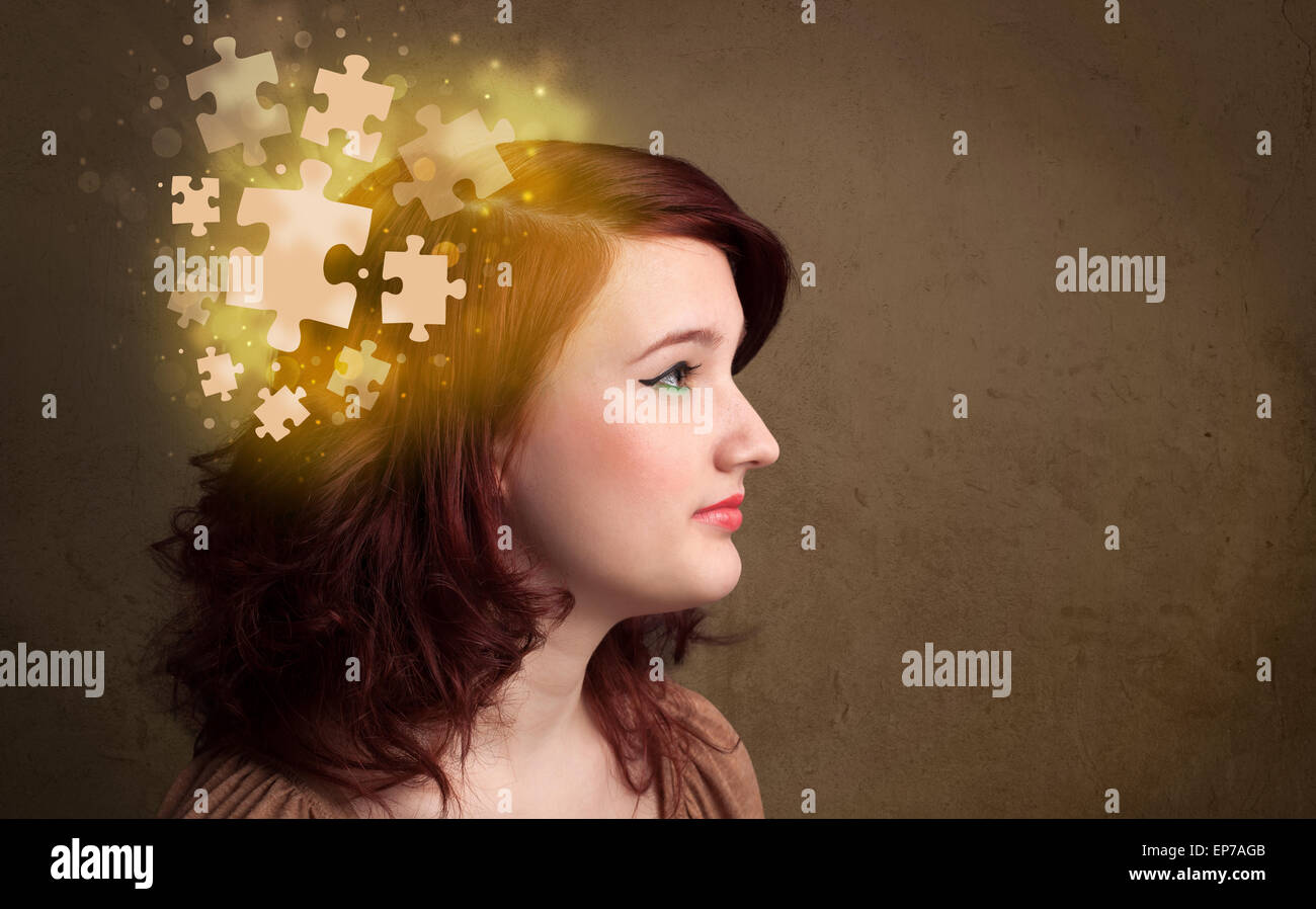 Young person thinking with glowing puzzle mind Stock Photo - Alamy